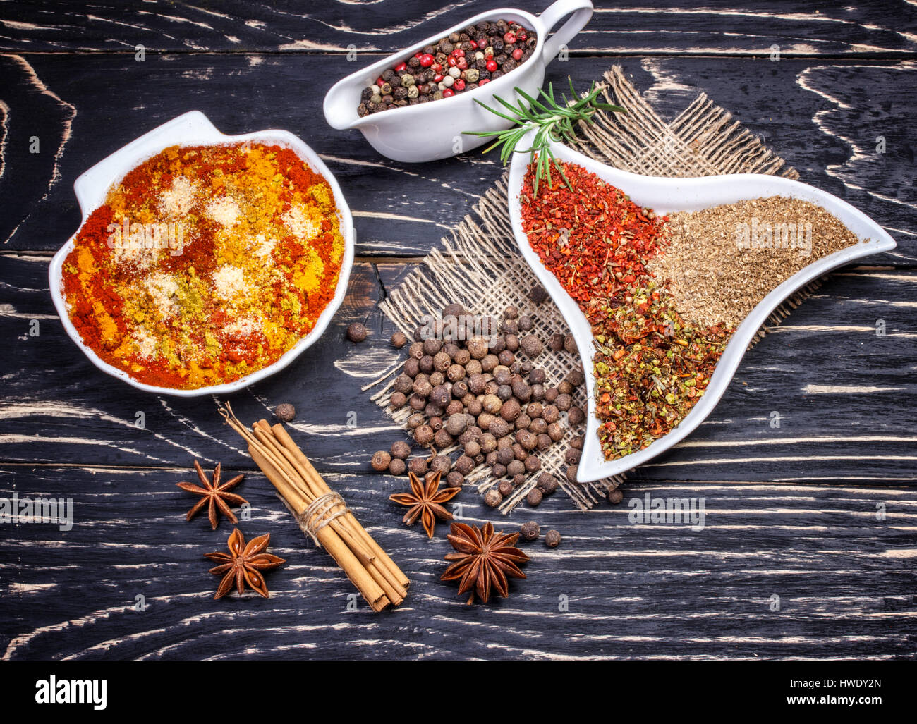 Colorful aromatic Indian spices and herbs on an old oak wooden brown ...