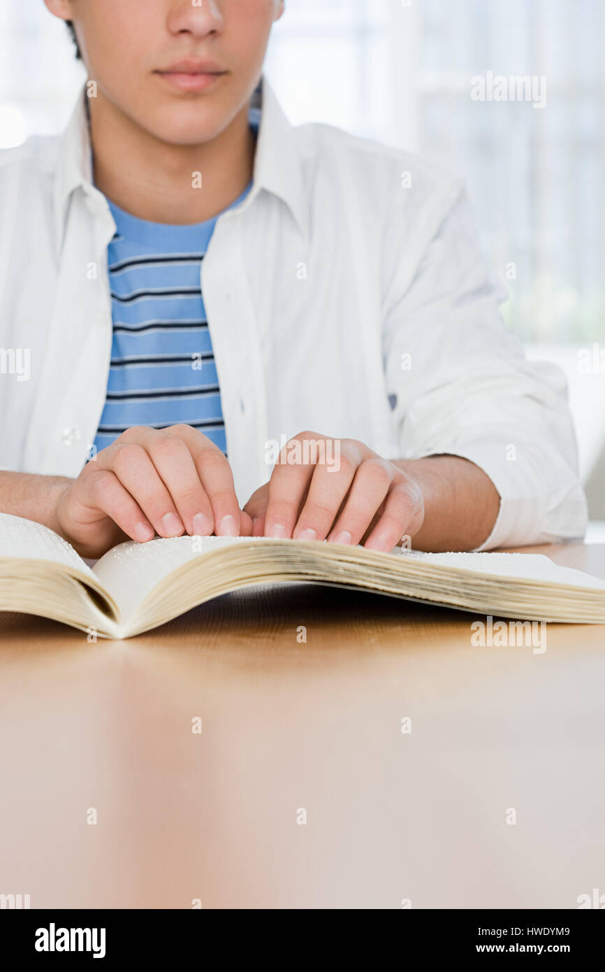 Blind boy reading a braille book Stock Photo - Alamy