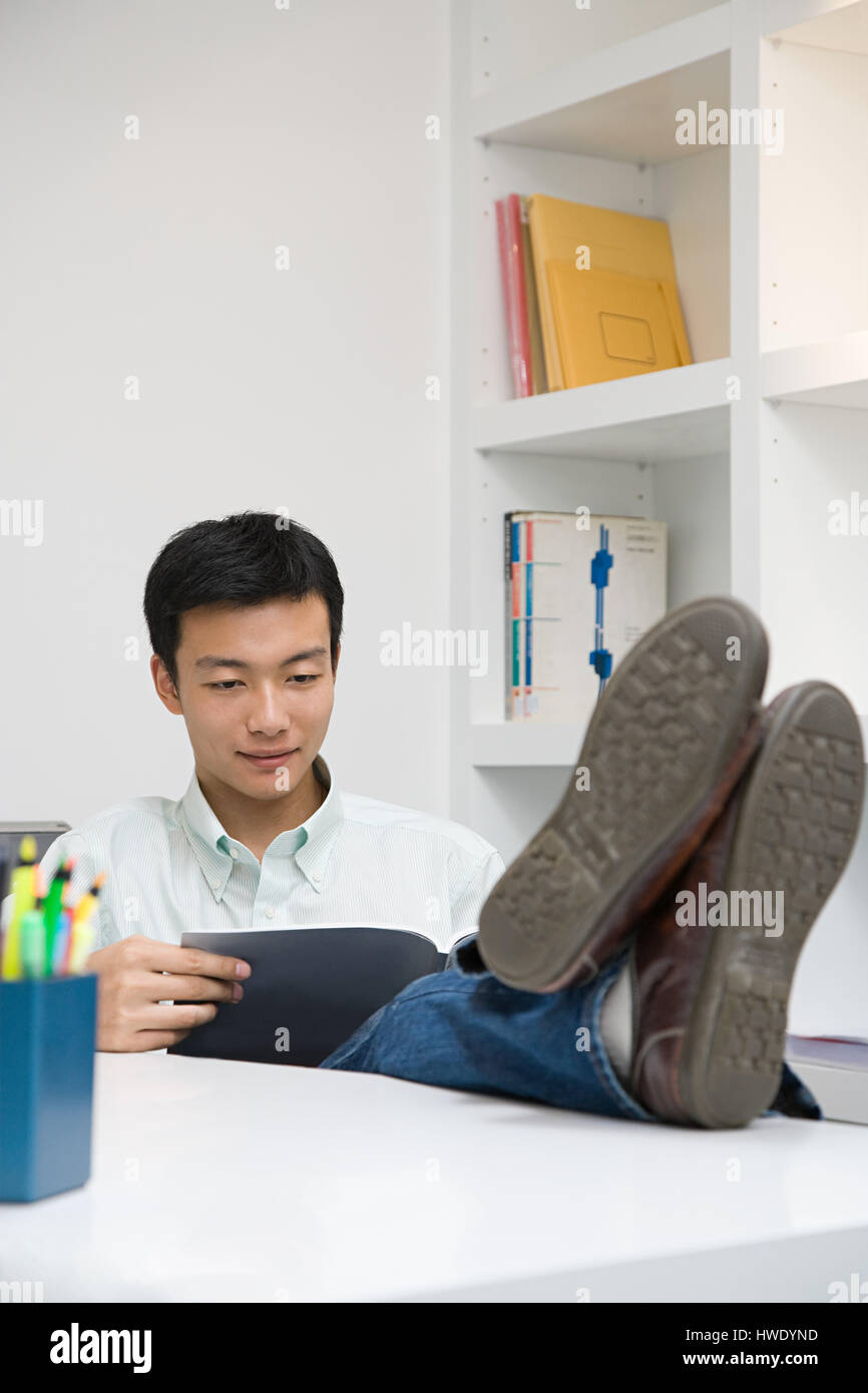 Man with feet on desk Stock Photo - Alamy