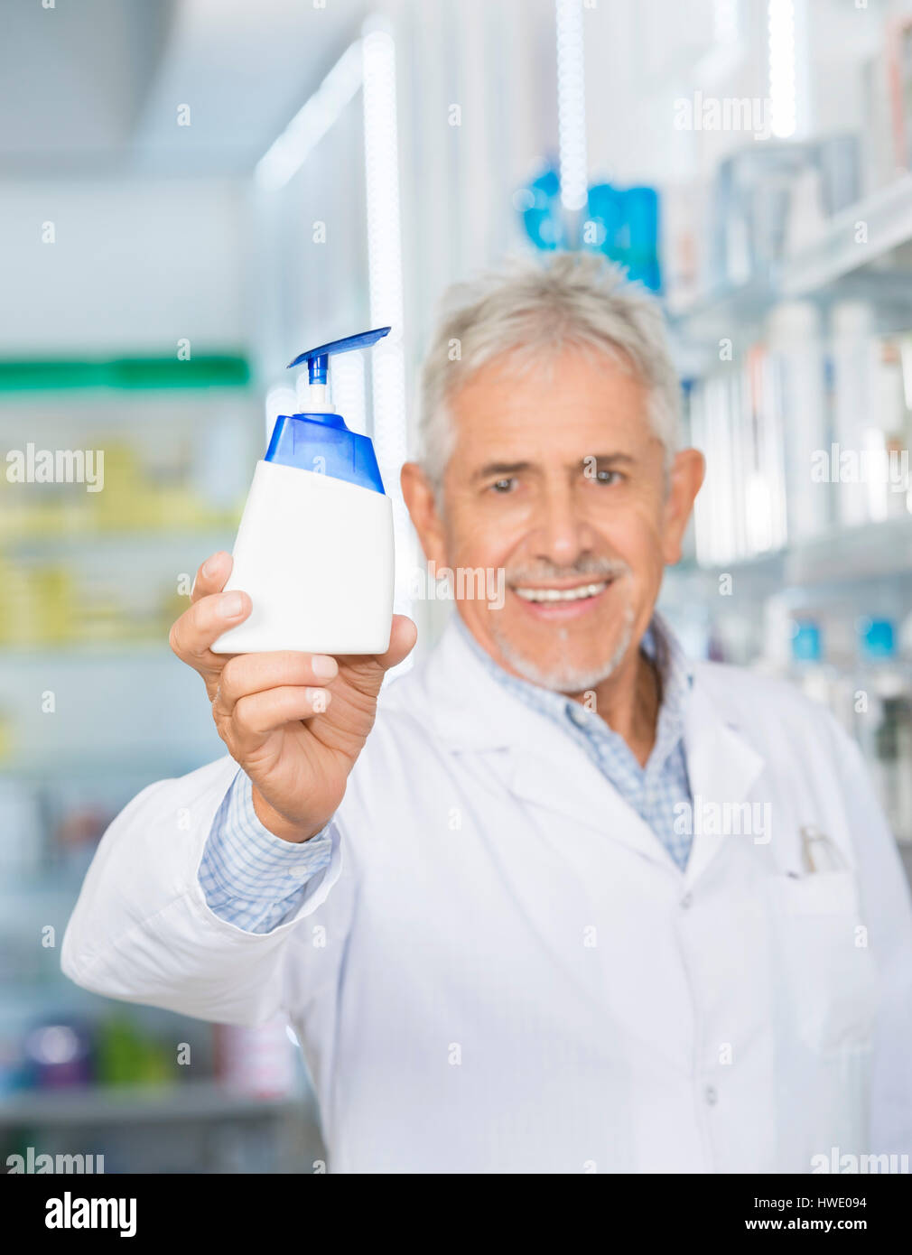 Pharmacist Smiling While Holding Soap Dispenser Stock Photo - Alamy