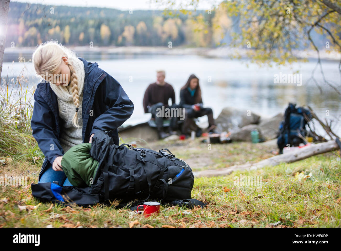 Young Woman Unpacking Backpack At Campsite Stock Photo - Alamy