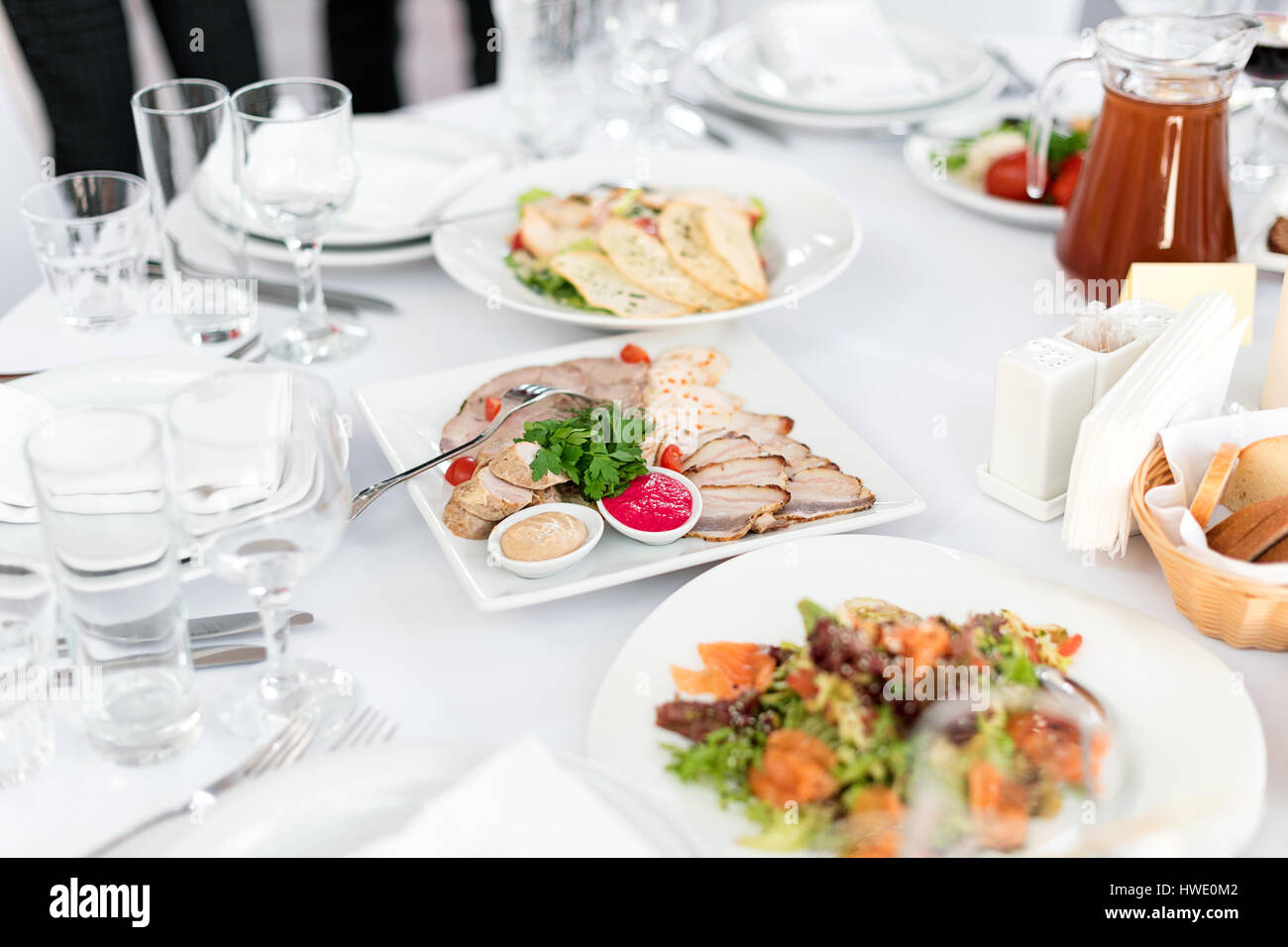 Restaurant table with food. Tasty appetizers, salads. Different meals ...
