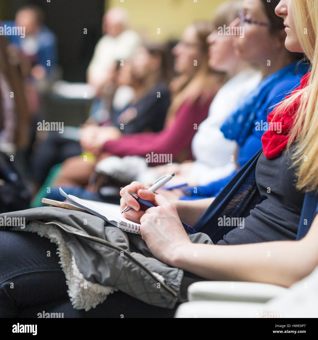 Hands holding pens and making notes at conference lecture Stock Photo ...