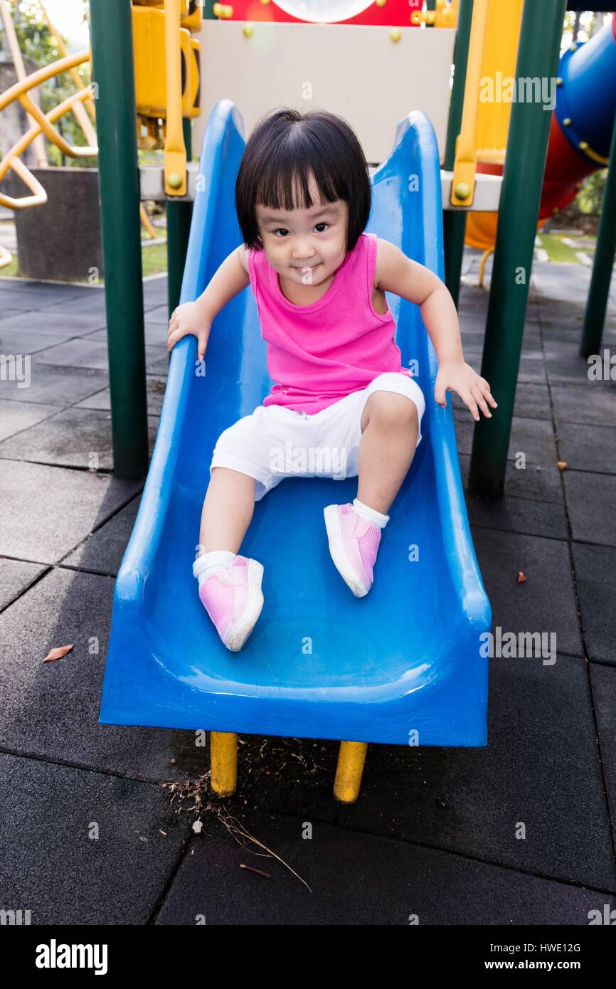 Asian Little Chinese Girl sliding at the playground Stock Photo - Alamy