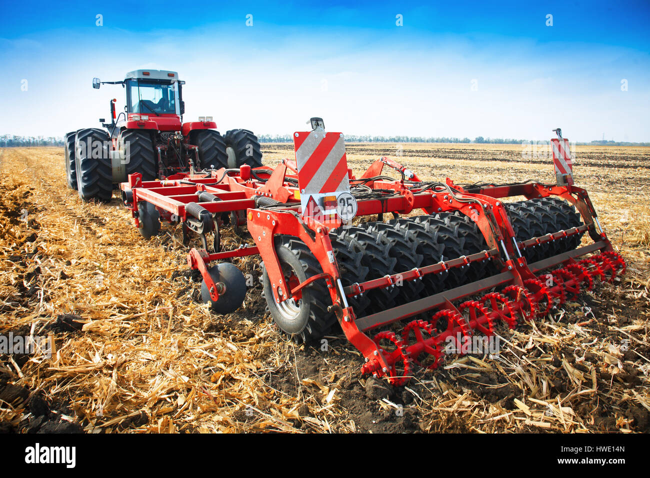 Modern tractor in the field with complex for the plowing of soil. The ...