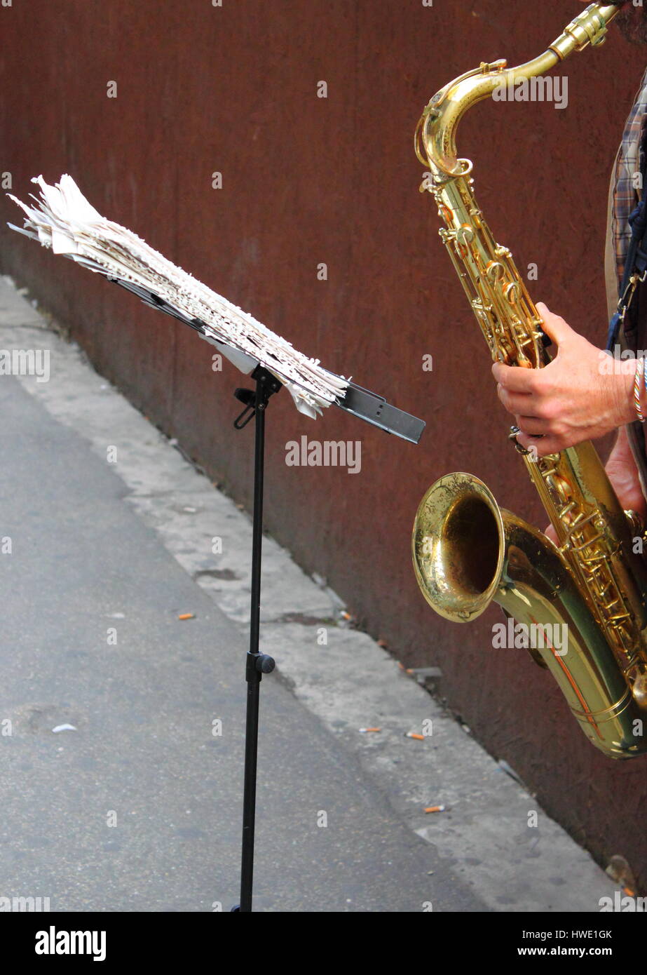Street sax player on a sidewalk Stock Photo - Alamy