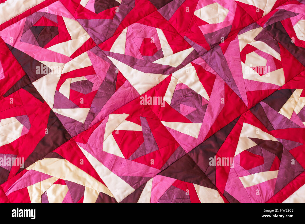 Part of color patchwork quilt with purple flowers pattern as background ...