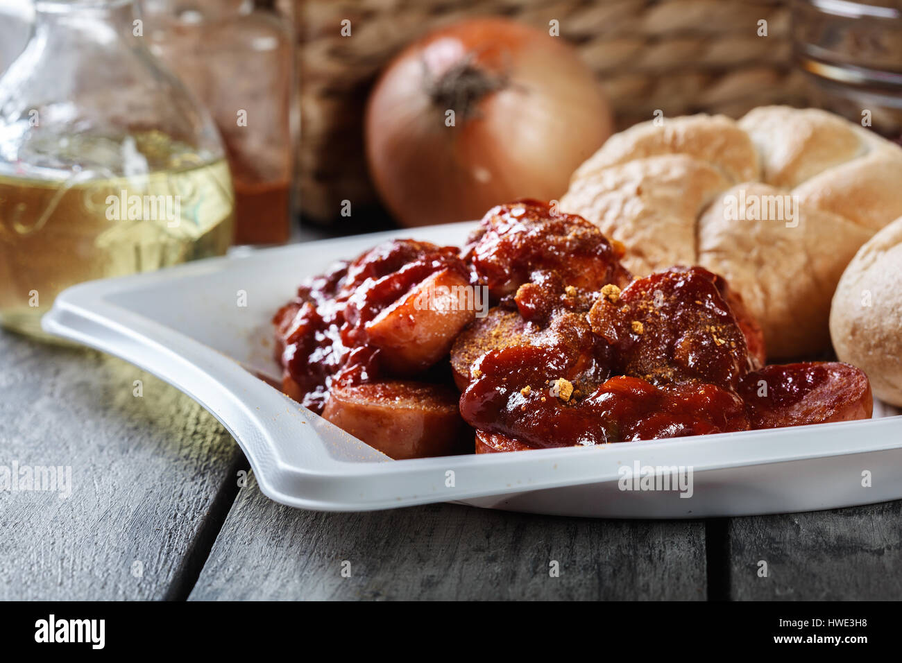 Delicious German currywurst - pieces of sausage with curry sauce and ...