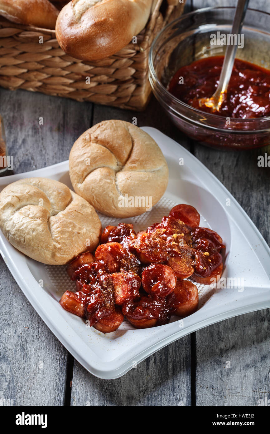 Delicious German currywurst - pieces of sausage with curry sauce and ...
