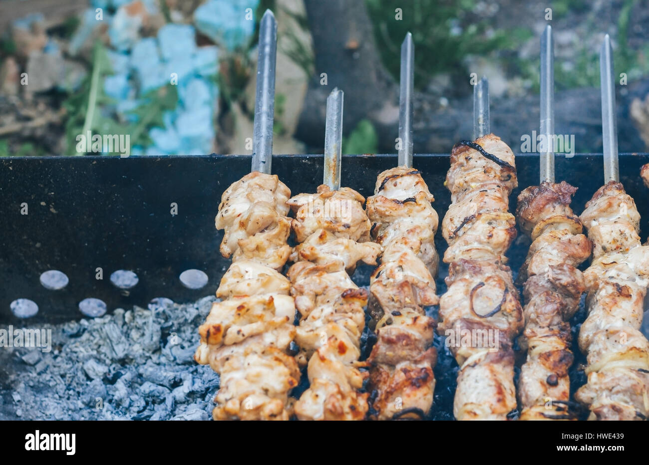 Cooking meat on the fire top view, shish kebab on skewers, smoke on the ...