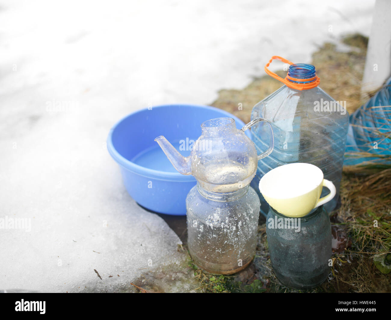 Filling various bowls, jars and kitchenware with springtime water ...
