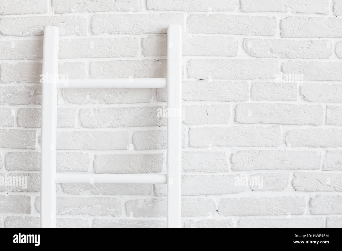 White brick wall with ladder Stock Photo - Alamy