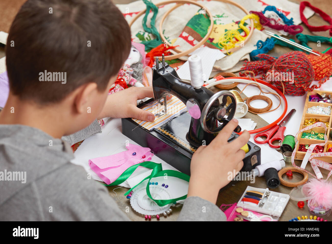 Boy sew clothes hi-res stock photography and images - Alamy