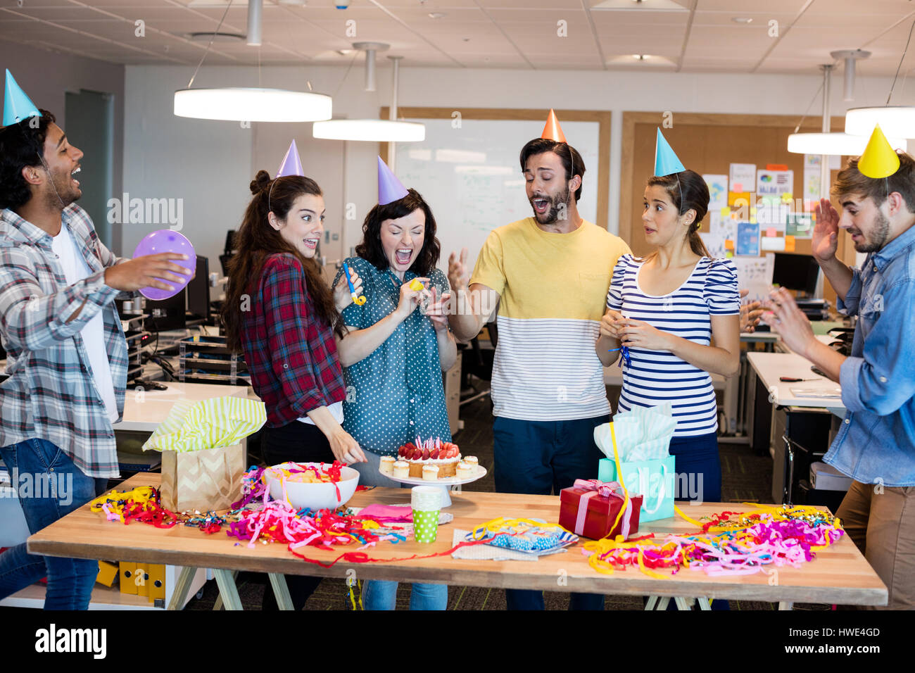 Creative business team celebrating colleagues birthday in office Stock ...