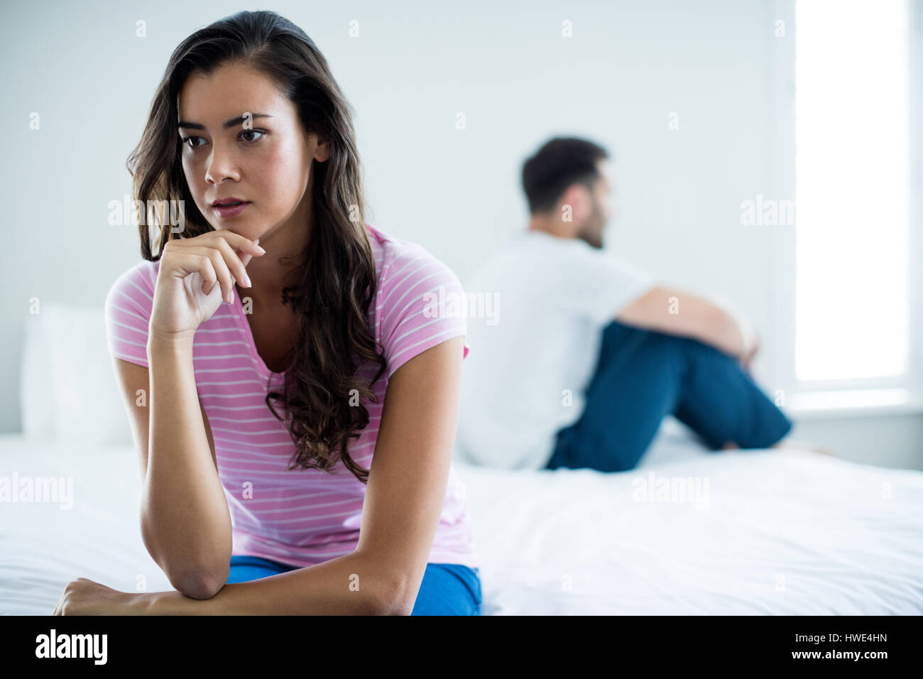 Couple ignoring each other in bedroom at home Stock Photo - Alamy