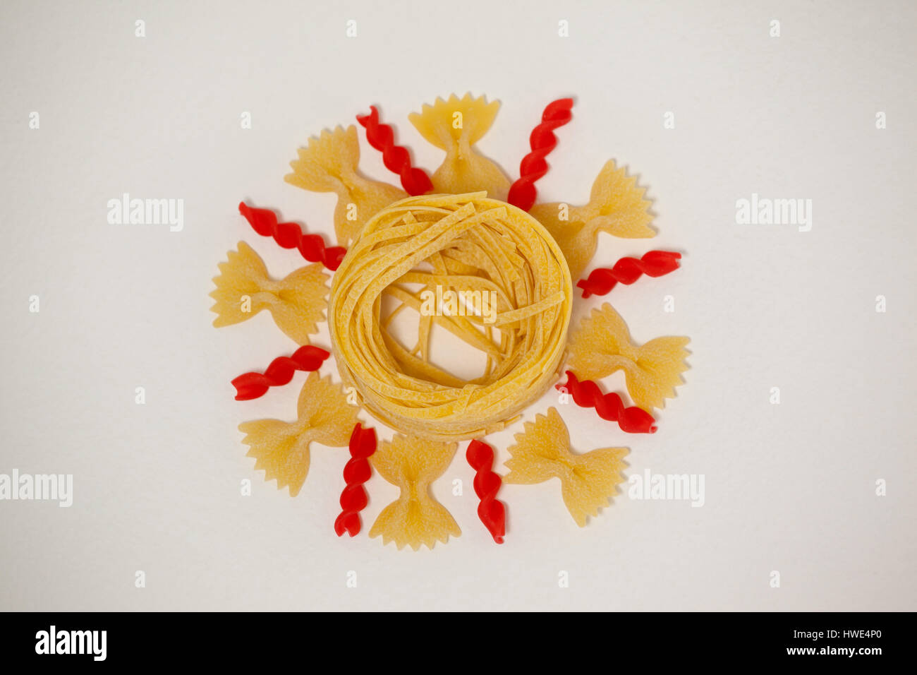 Varieties of pasta making a flower on white background Stock Photo - Alamy