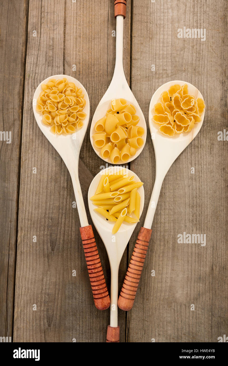 Spoons filled with varieties of pasta on white background Stock Photo ...