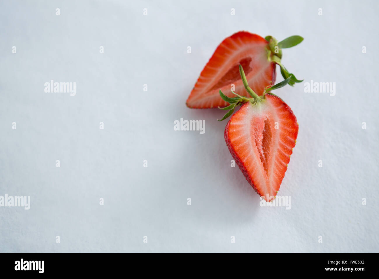 Ripe tasty strawberry cut into two halves on white background Stock ...
