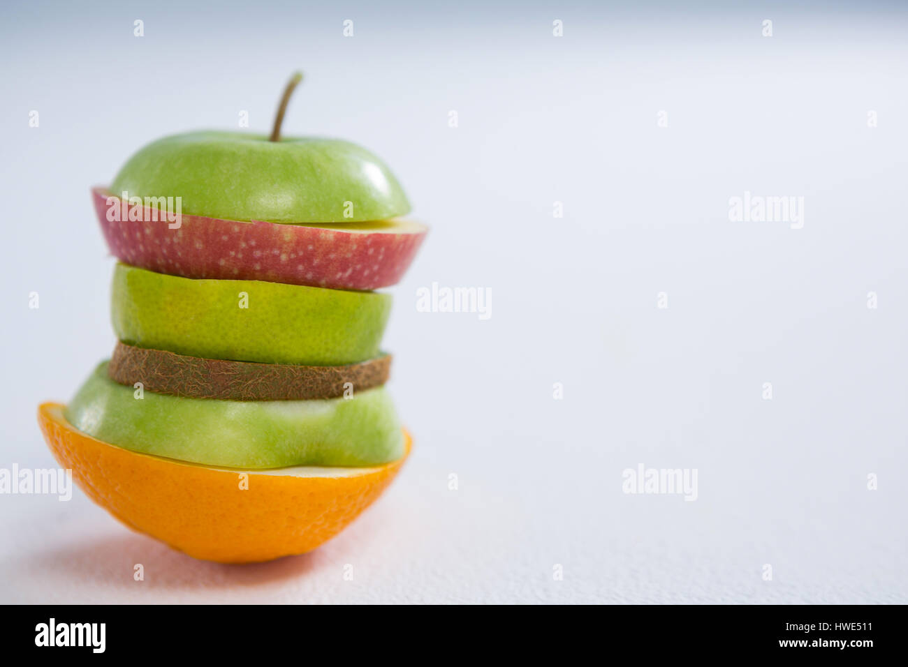 Stack of various fruits slices against white background Stock Photo - Alamy