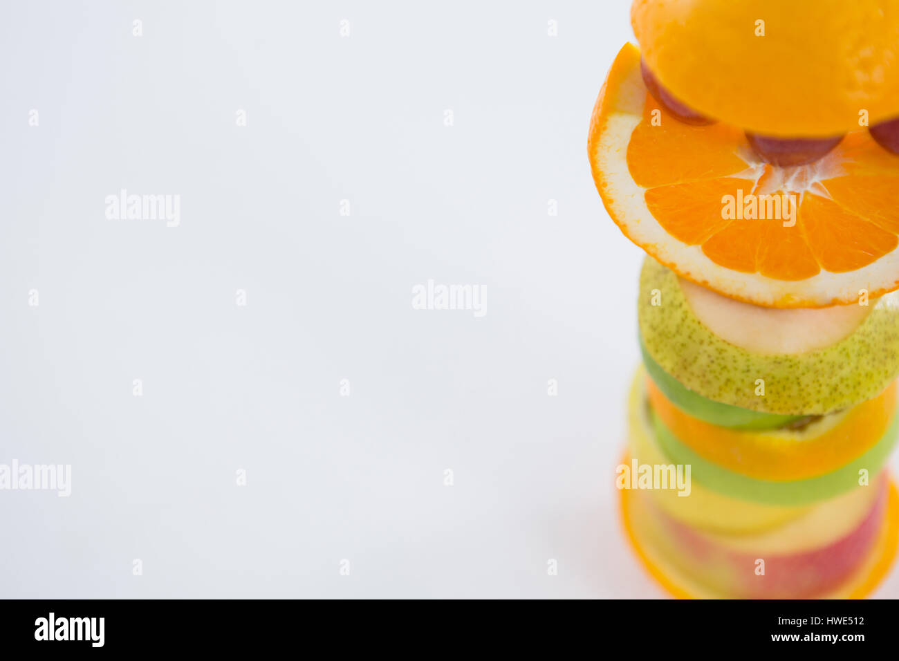 Stack of various fruits slices against white background Stock Photo - Alamy