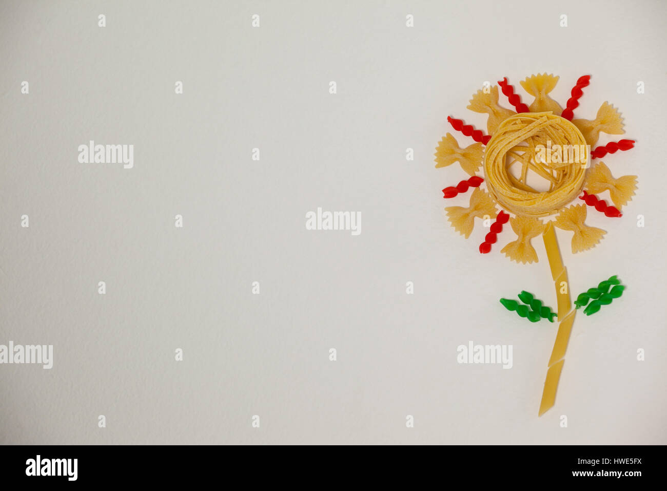 Varieties of pasta making a flower on white background Stock Photo - Alamy