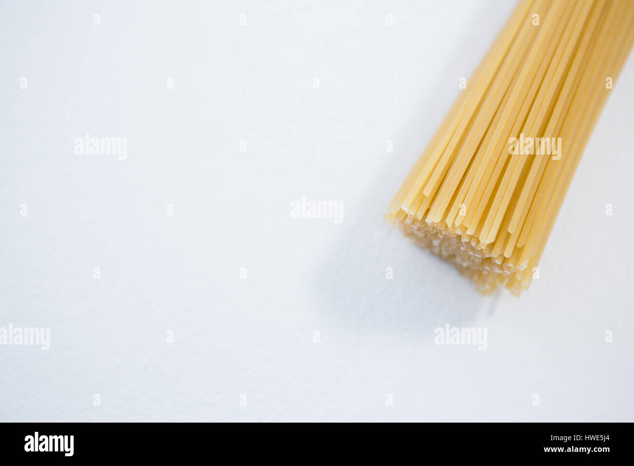 Bunch of raw spaghetti on white background Stock Photo - Alamy