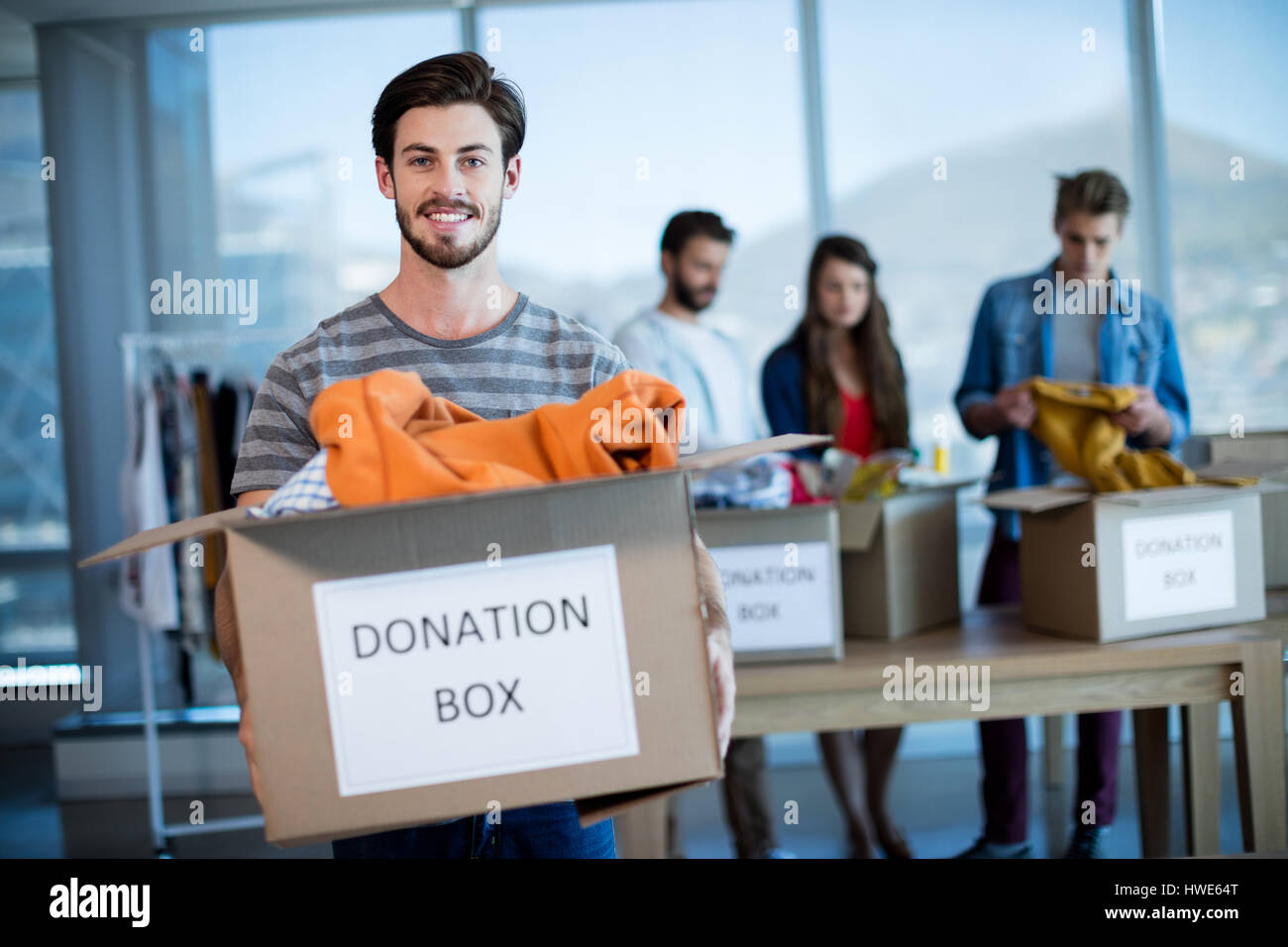 Smiling man carrying box personal hi-res stock photography and images ...
