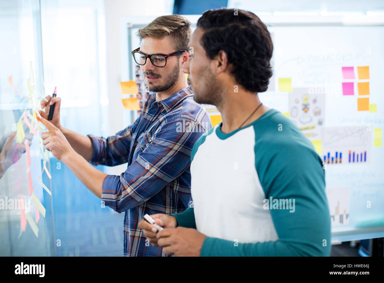 Creative business team writing on the sticky notes in office Stock ...