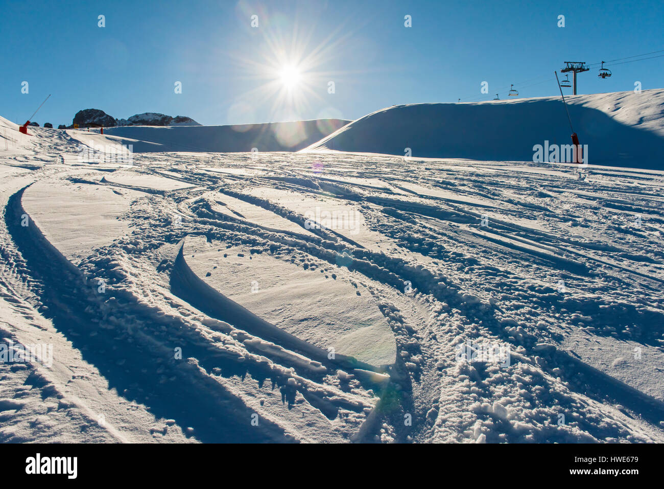 Ski slope piste in winter alpine mountain resort with powder snow ...