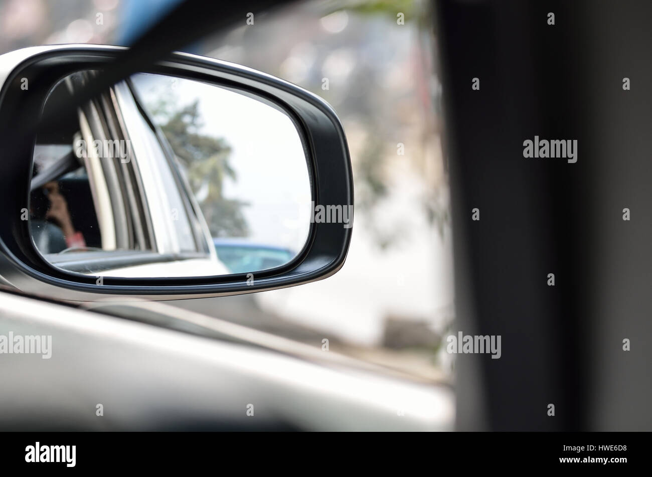 Rear view mirror reflecting car Stock Photo - Alamy