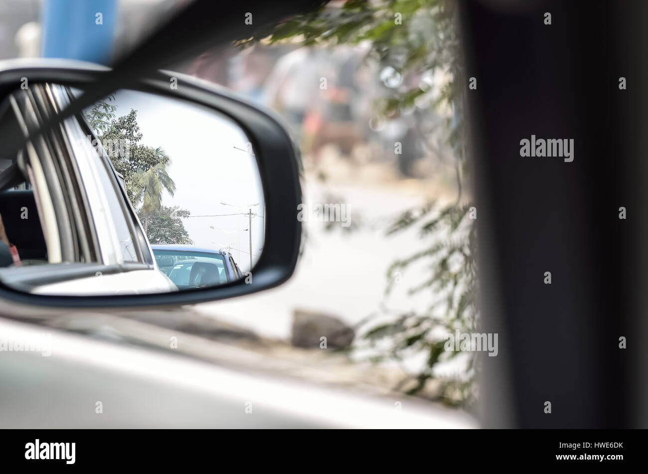 Rear view mirror reflecting car Stock Photo - Alamy