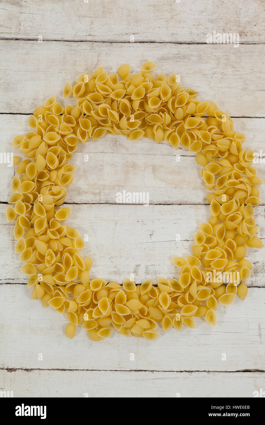 Fettuccine pasta forming a circle on wooden table Stock Photo - Alamy