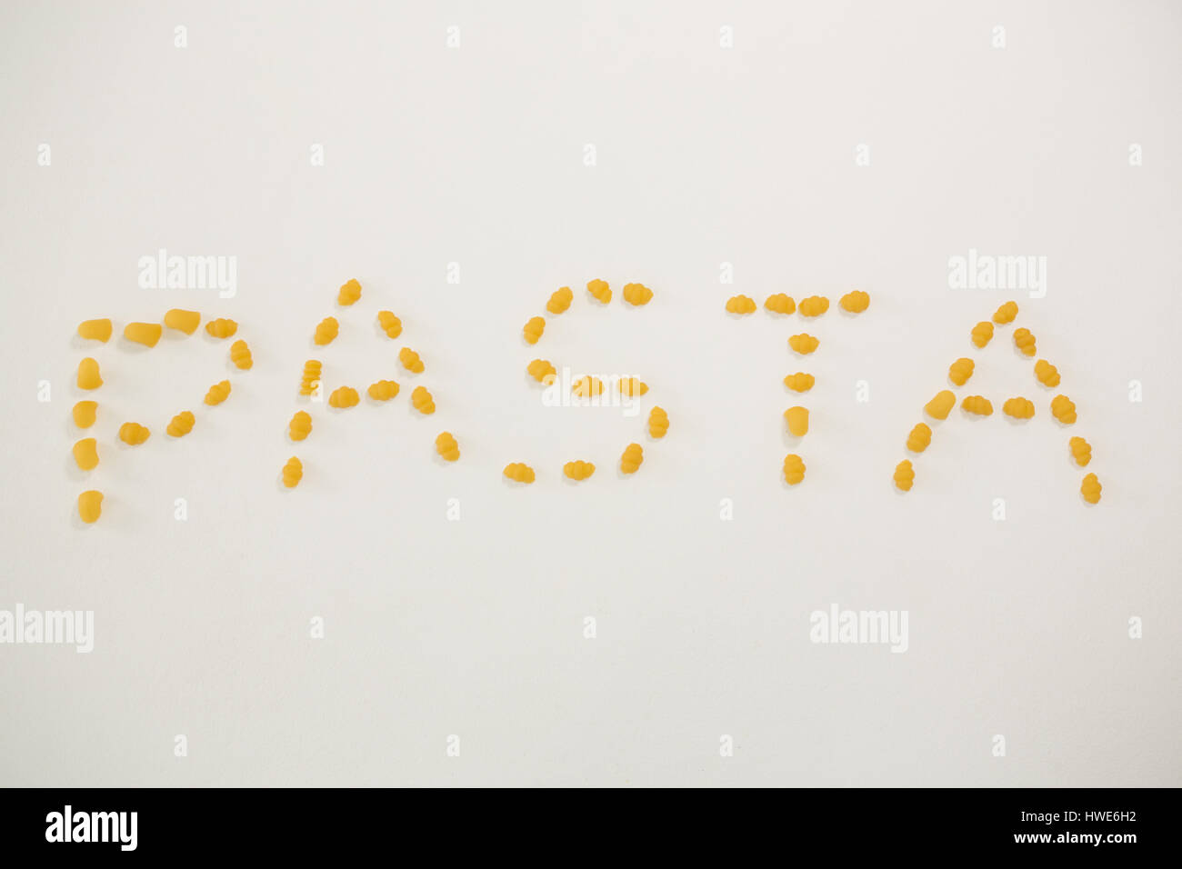 Various pasta arranged in shape of pasta text on white background Stock ...