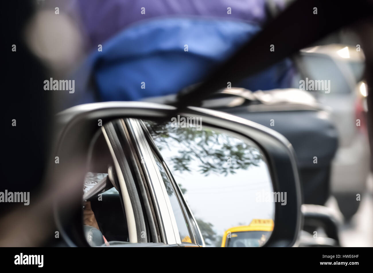 Rear view mirror reflecting car Stock Photo - Alamy