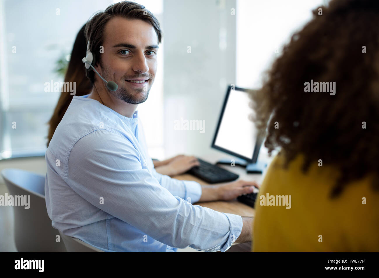 Portrait of customer service executive working at office Stock Photo ...