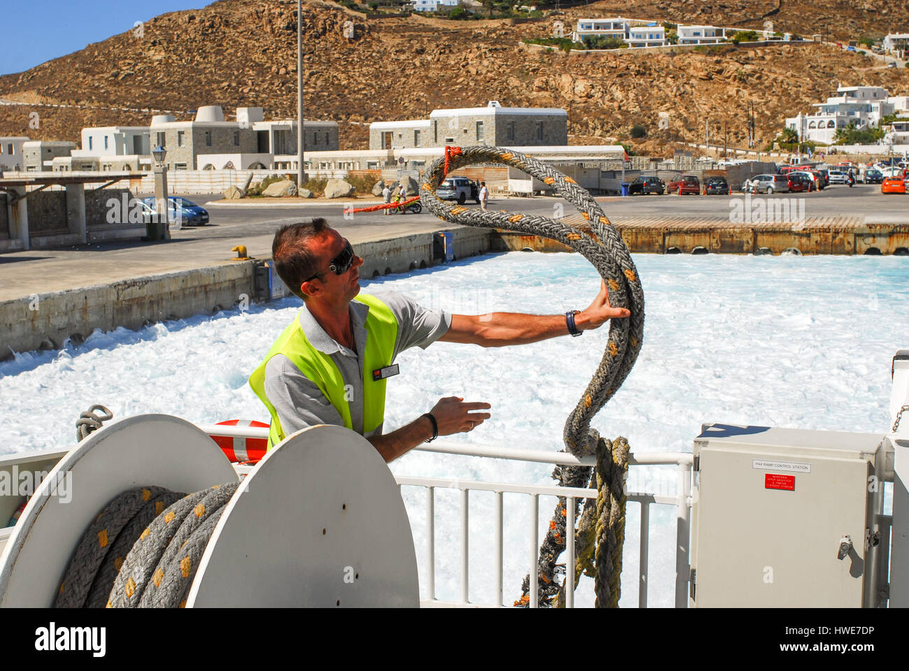 Greek ferry operator casting a rope after departing from port Stock ...