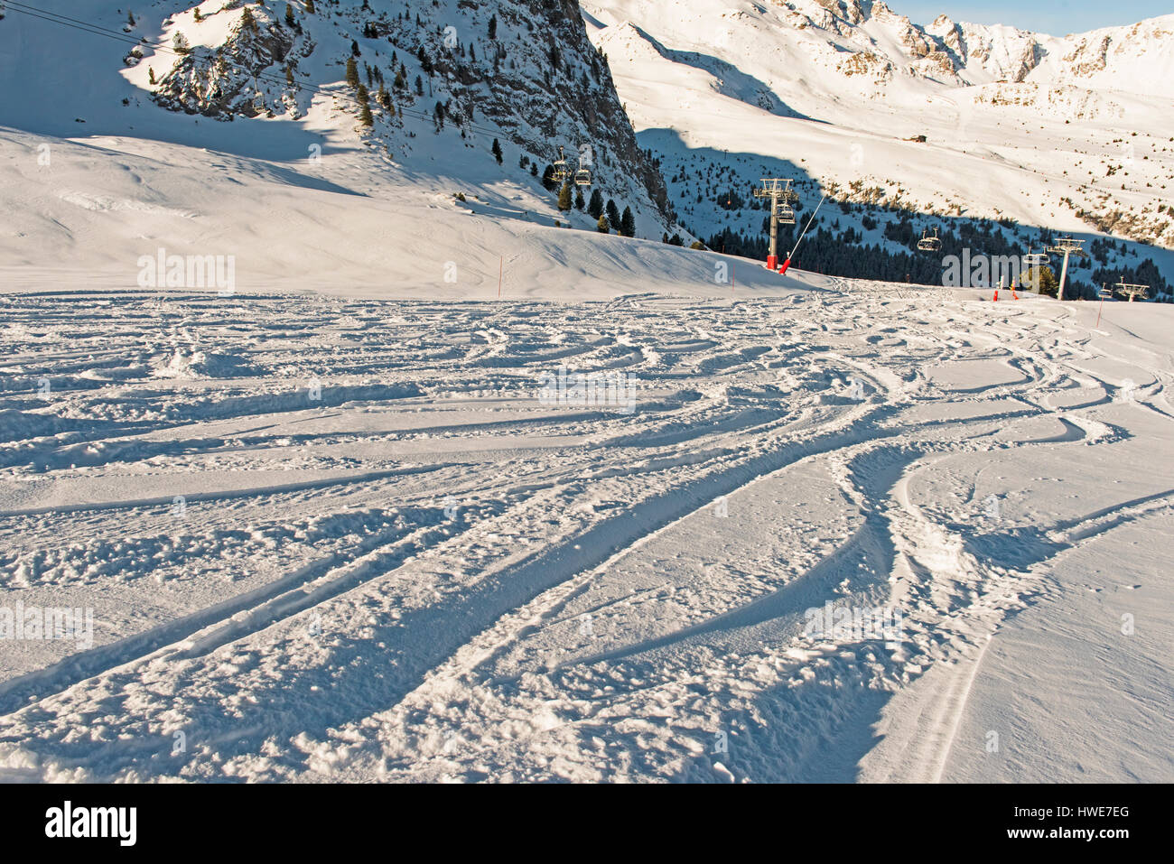 Ski slope piste in winter alpine mountain resort with powder snow ...