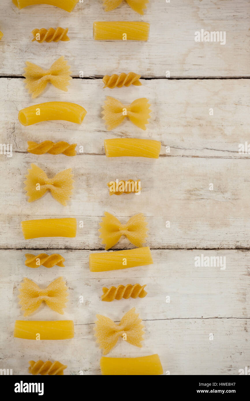 Varieties of pasta arranged on wooden background Stock Photo - Alamy