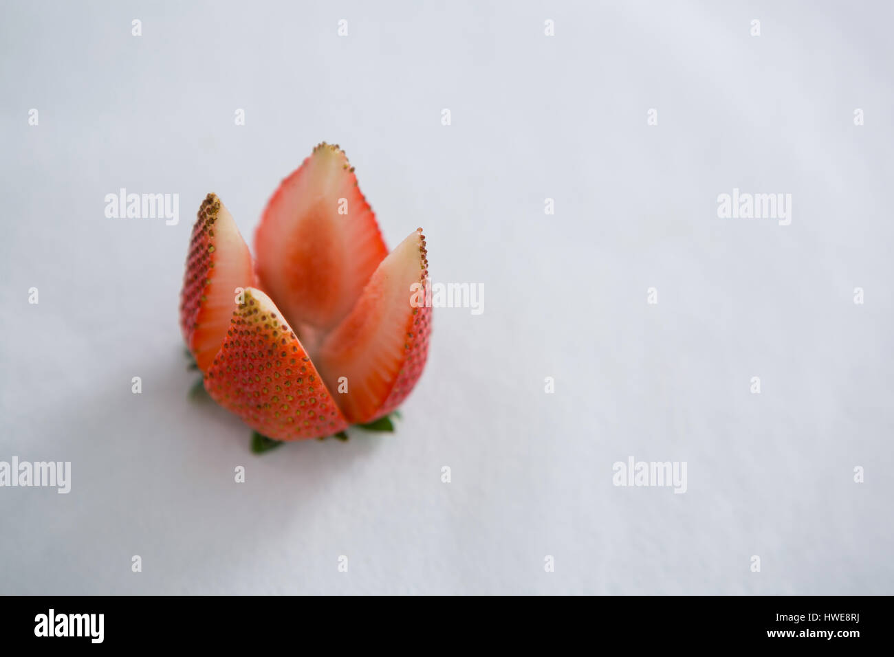 Close-up of strawberry cut in a flower shape on white background Stock ...