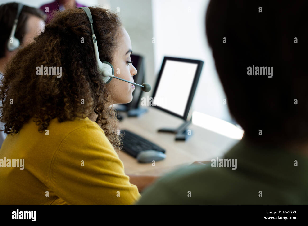 Customer service executive working at office Stock Photo - Alamy