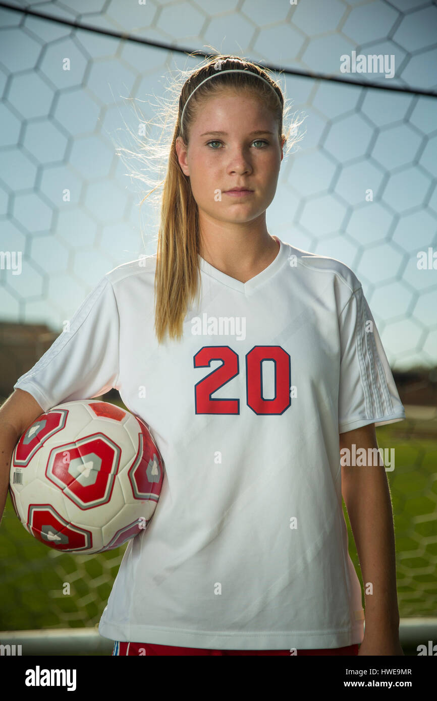 Proud goalie holding soccer ball in goal on sunny day Stock Photo - Alamy