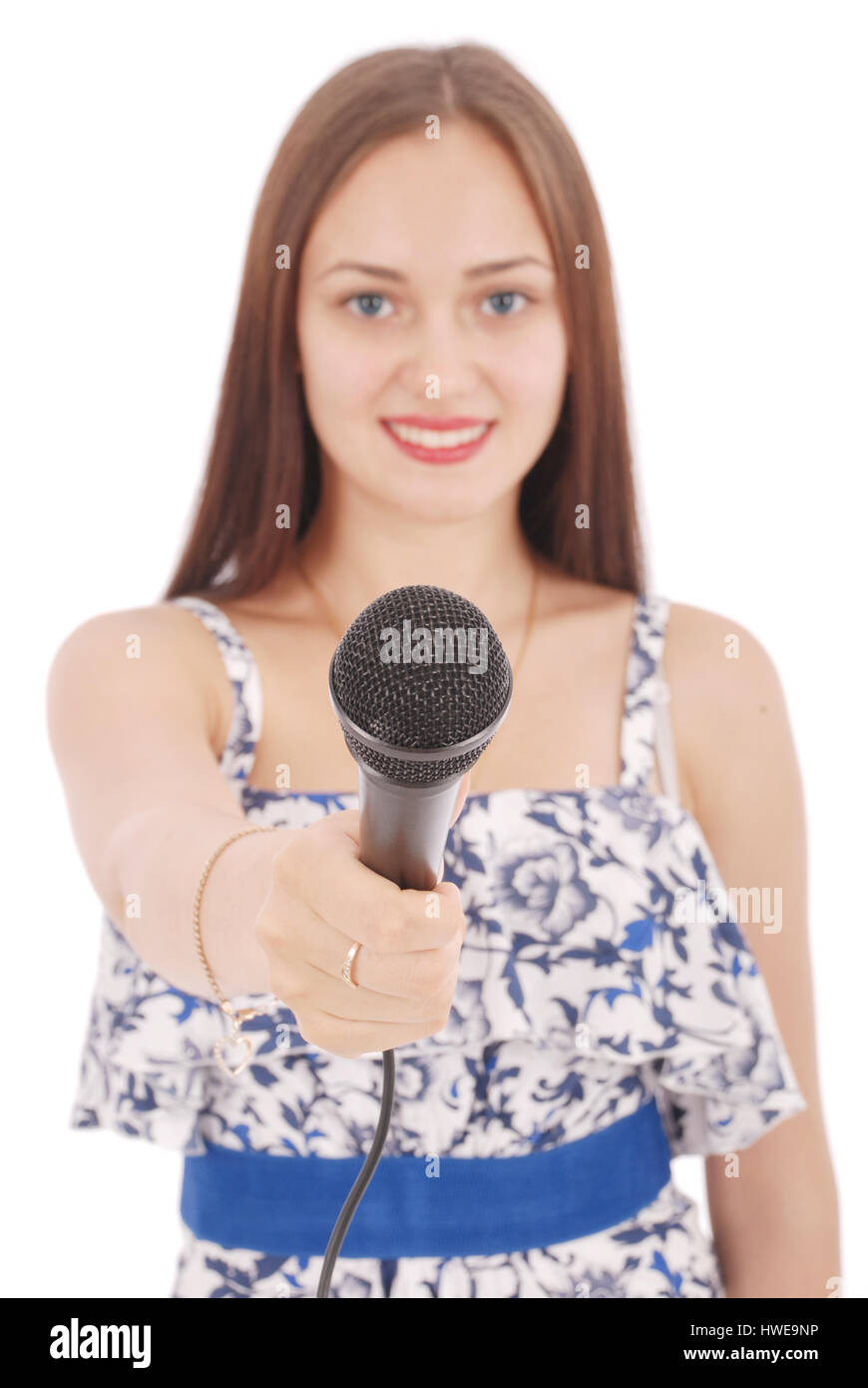 Happy young beautiful girl singing with microphone isolated on white ...