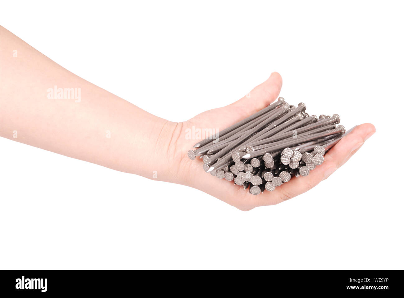 Man's hand holding metal nails. Closeup with clipping path isolated on ...
