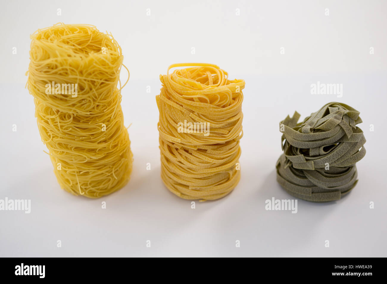 Various pasta arranged in a row on white background Stock Photo - Alamy