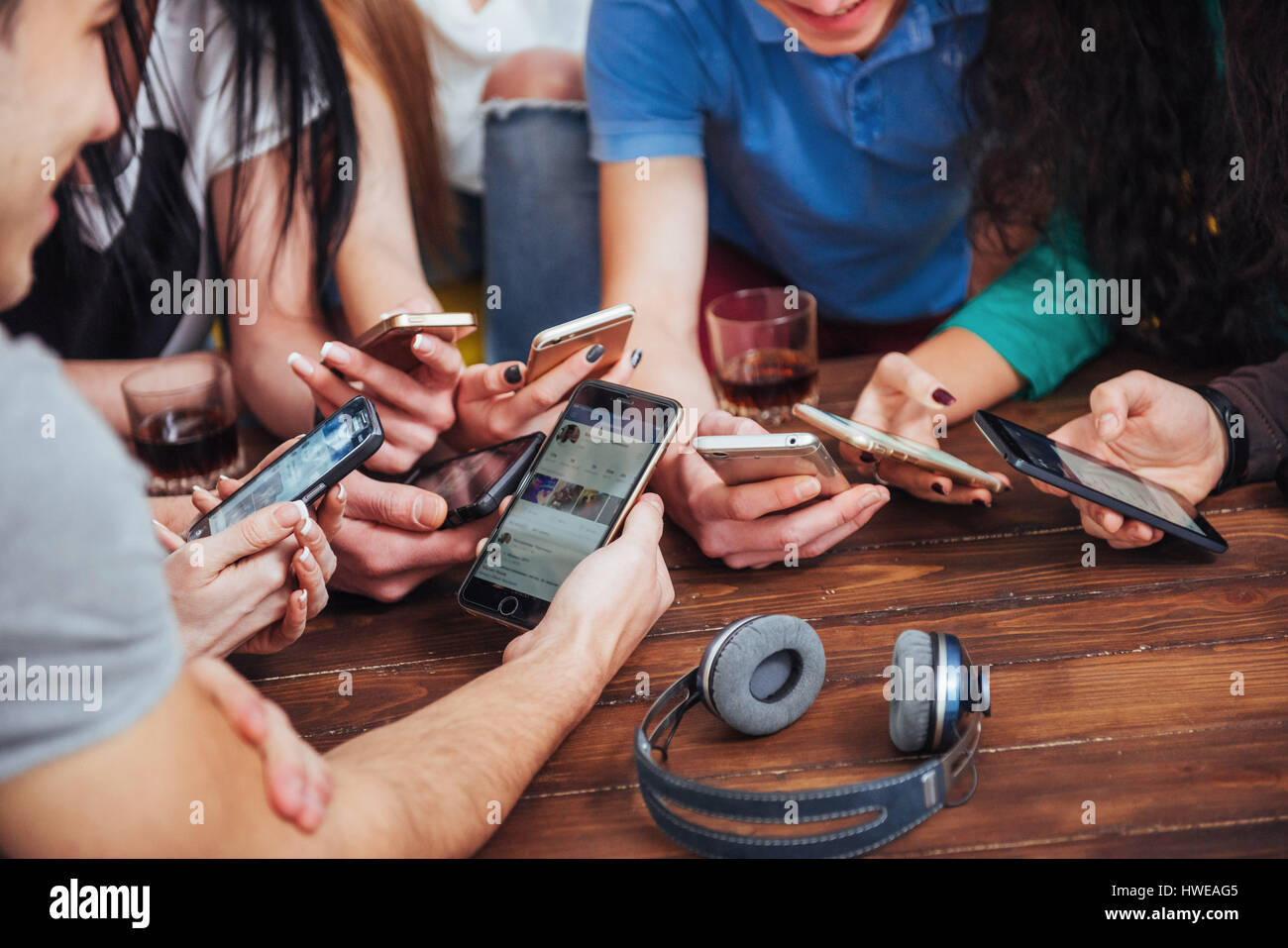 Top view hands circle using phone in cafe - Multiracial friends mobile ...