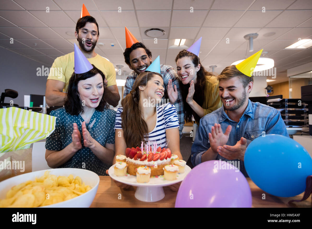 Creative business team celebrating colleagues birthday in office Stock ...