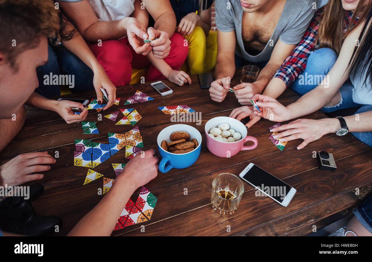 Top view creative photo of friends sitting at wooden table. Friends ...