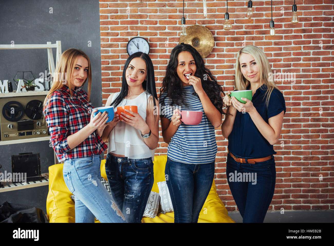 Group beautiful young people enjoying in conversation and drinking ...