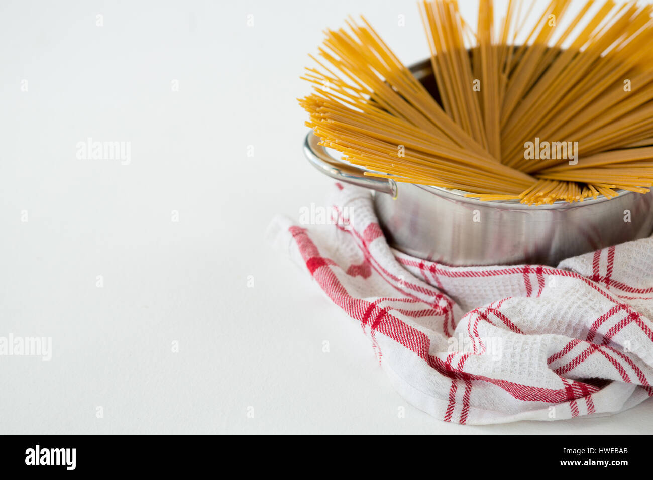 Spaghetti pasta arranged in utensil on white background Stock Photo - Alamy