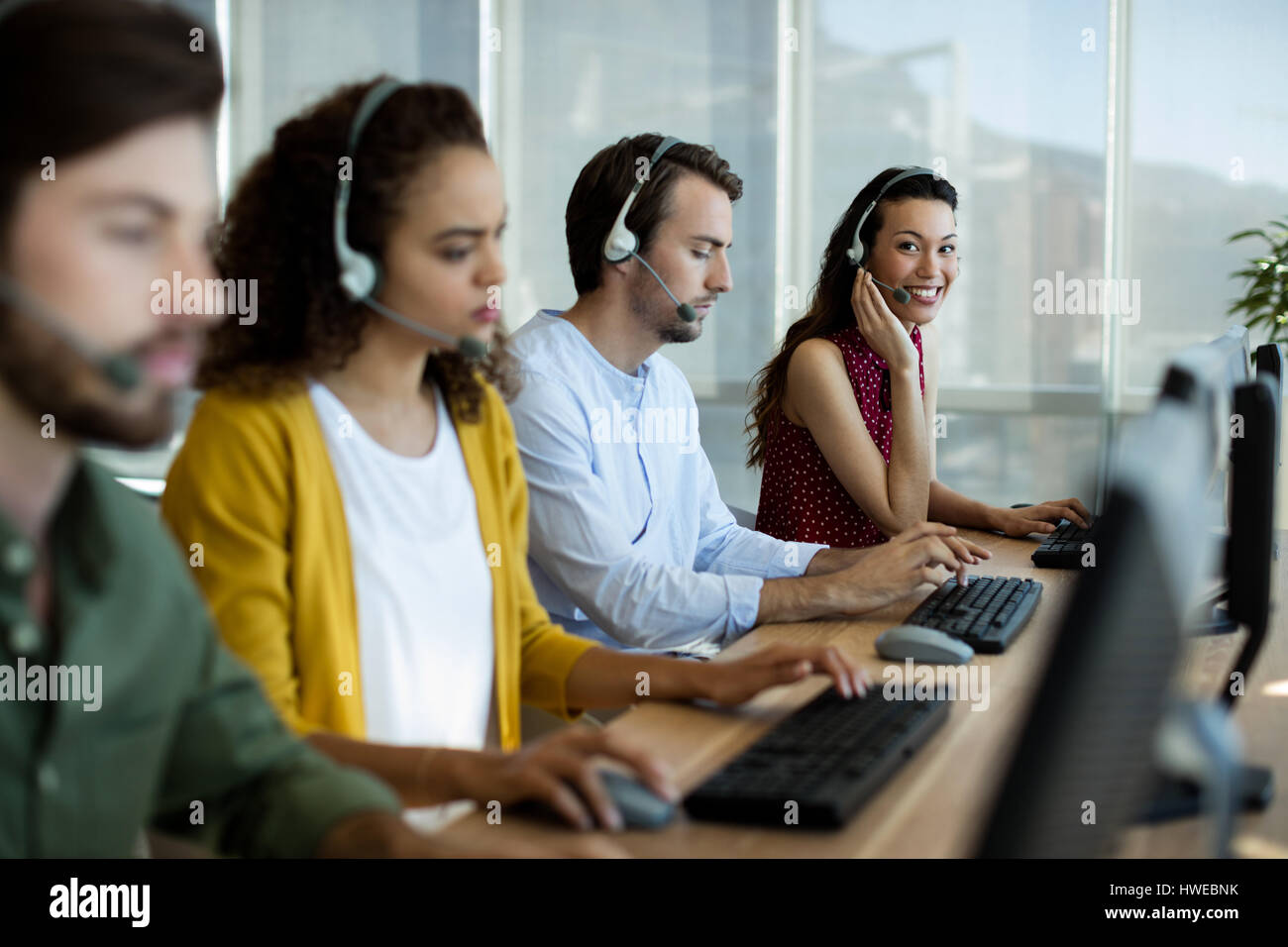 Portrait of customer service executive working at office Stock Photo ...